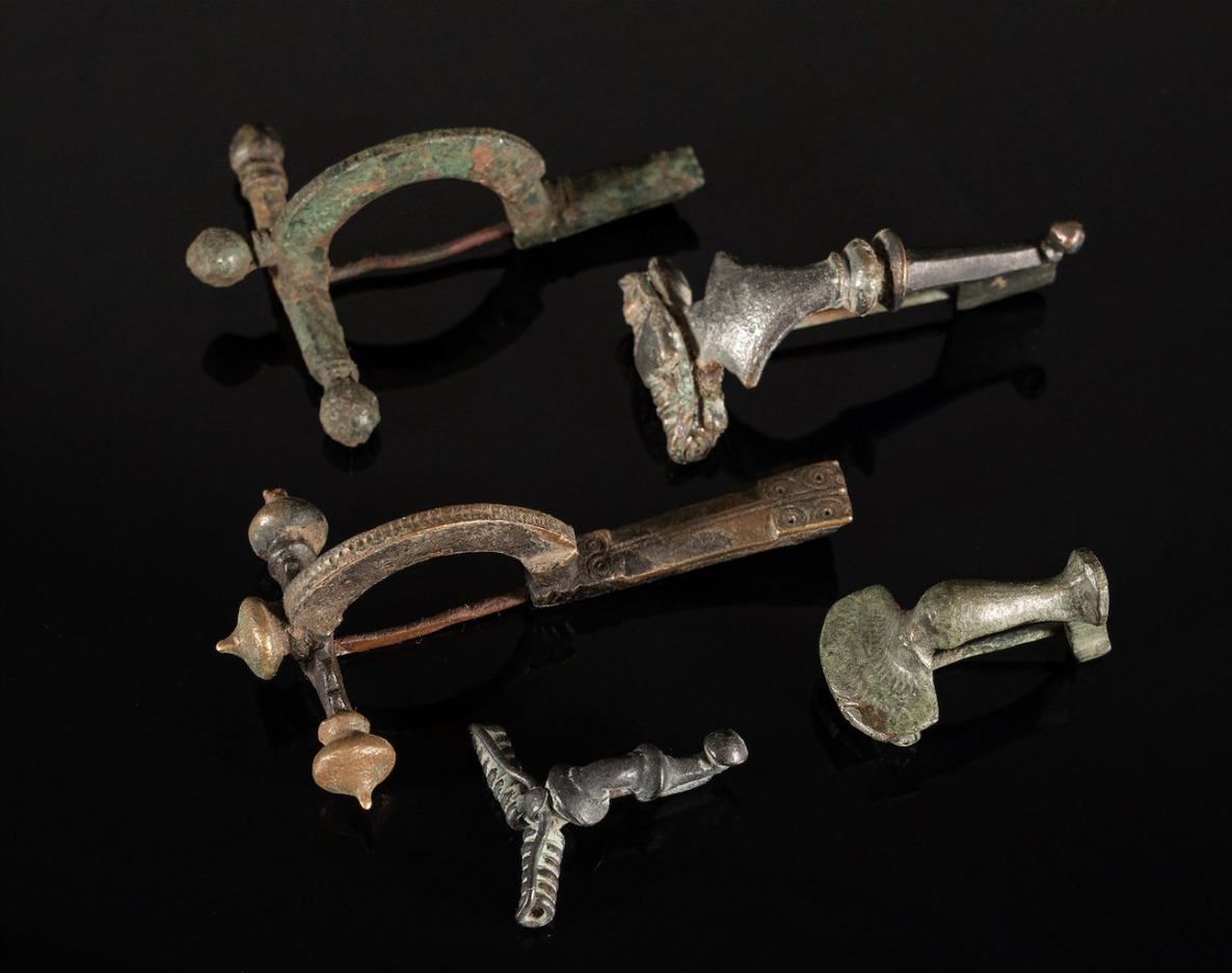 Collection of Roman dress brooches, onion button brooches and other ...